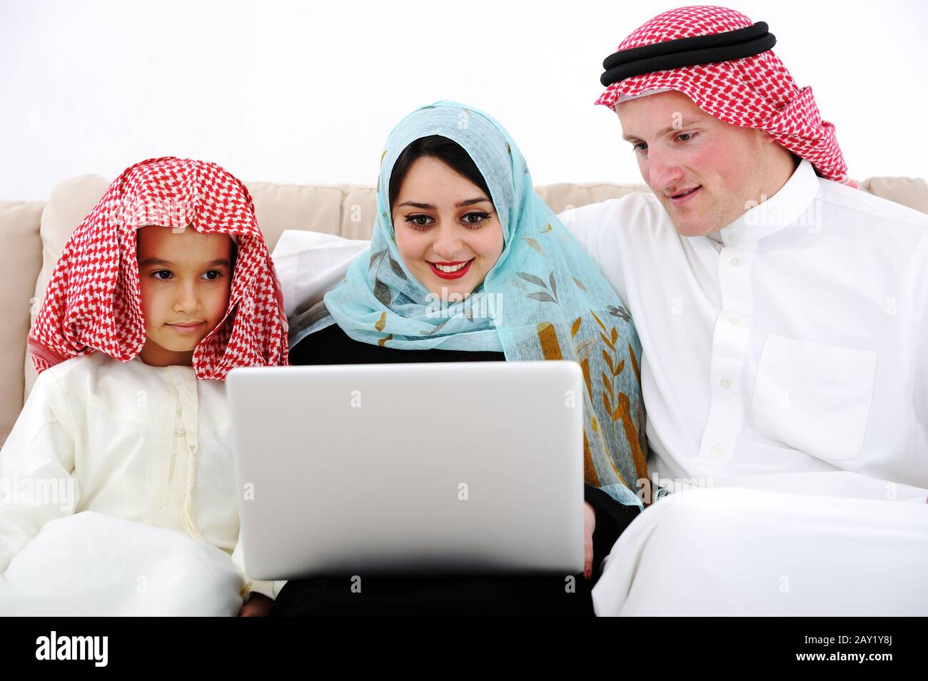 Arabic parents and little boy at home with laptop computer Stock Photo ...