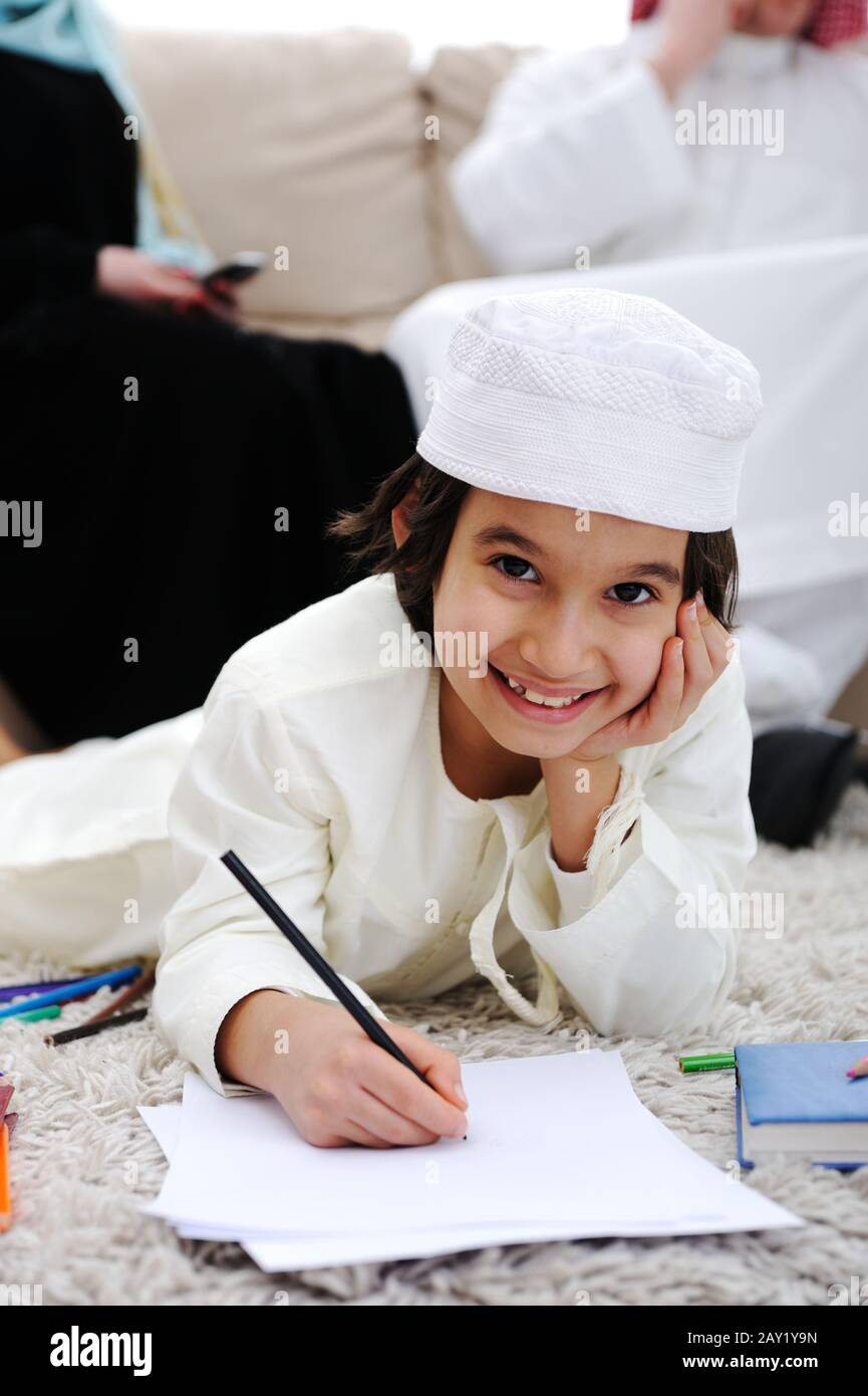 Happy child working on homework at home with his family Stock Photo - Alamy