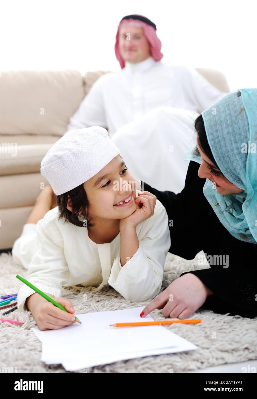 Happy child working on homework at home with his family Stock Photo - Alamy