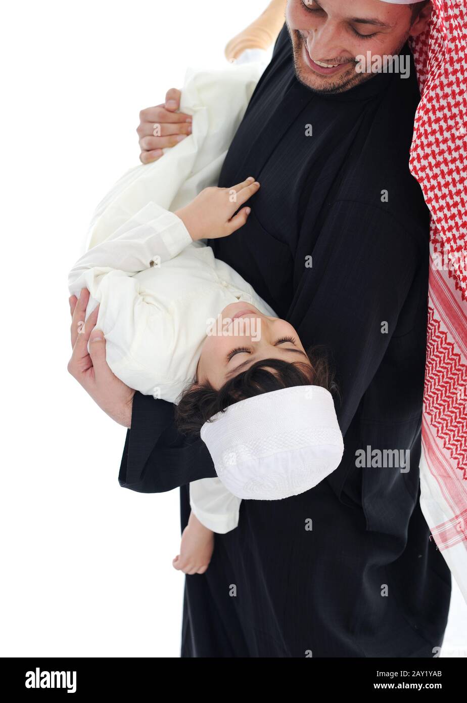 Arabic Muslim father and son standing together Stock Photo - Alamy