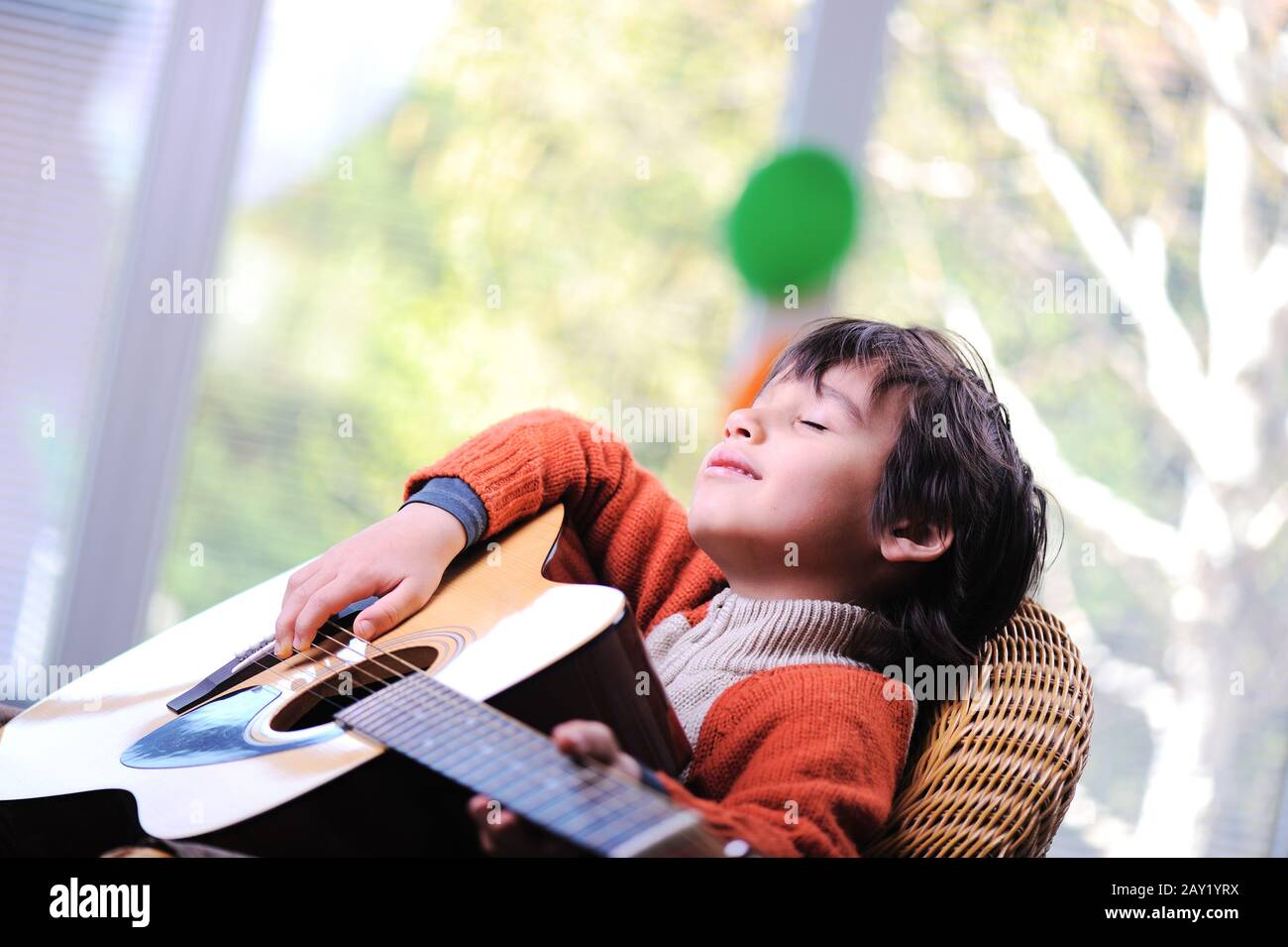 Kid playing guitar at home Stock Photo - Alamy