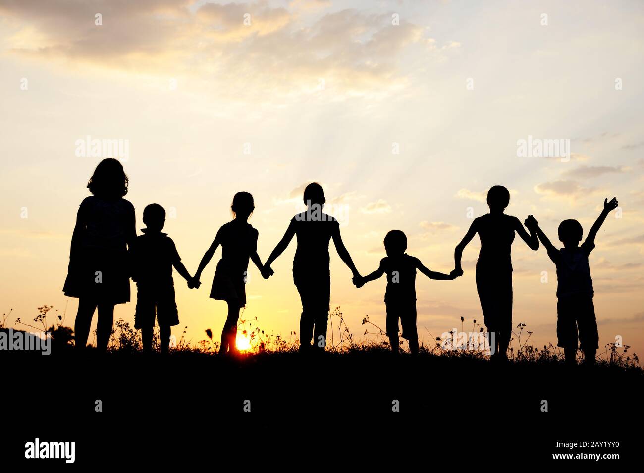 Group of children playing at summer sunset Stock Photo - Alamy