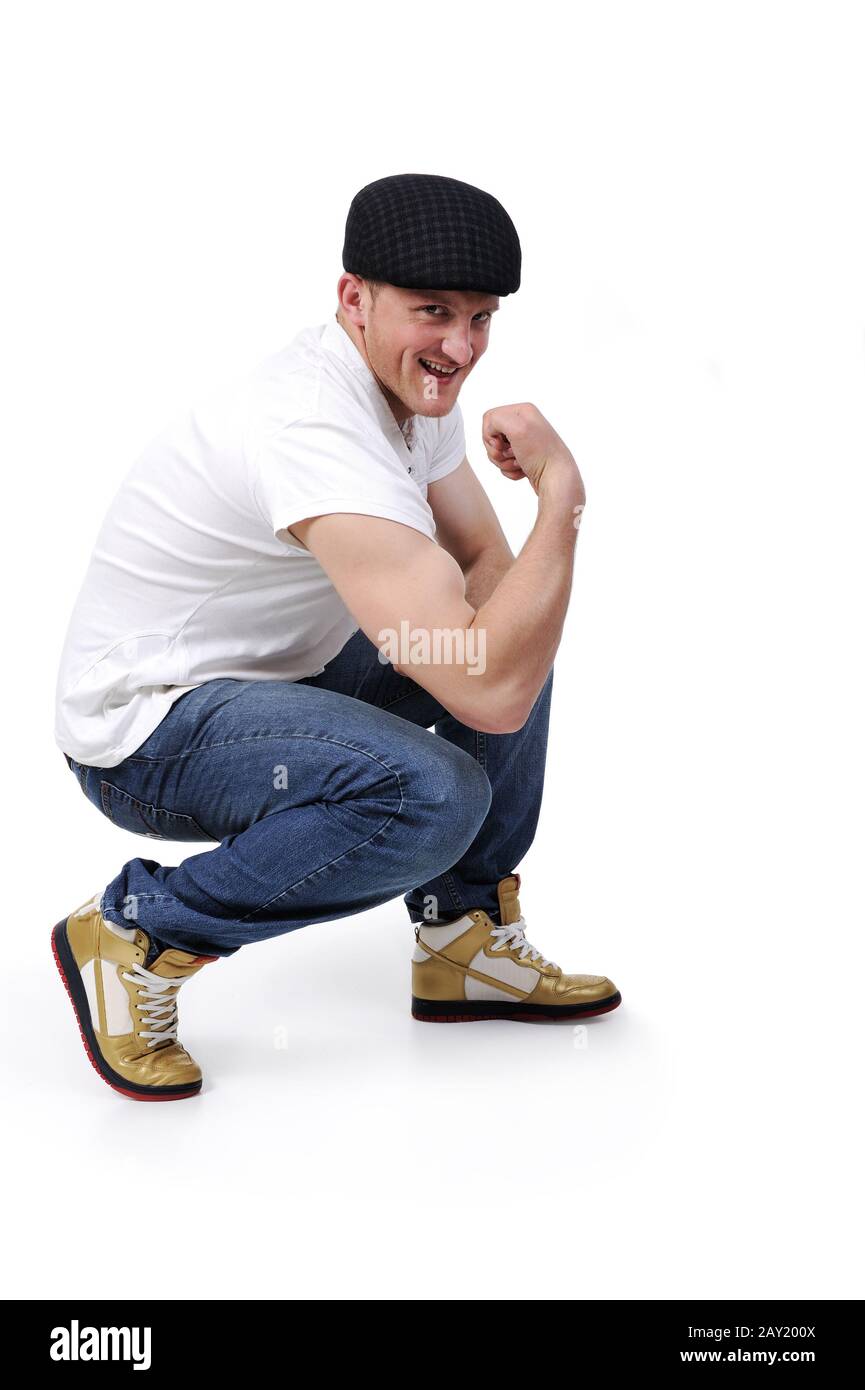 Young happy man crouching Stock Photo - Alamy
