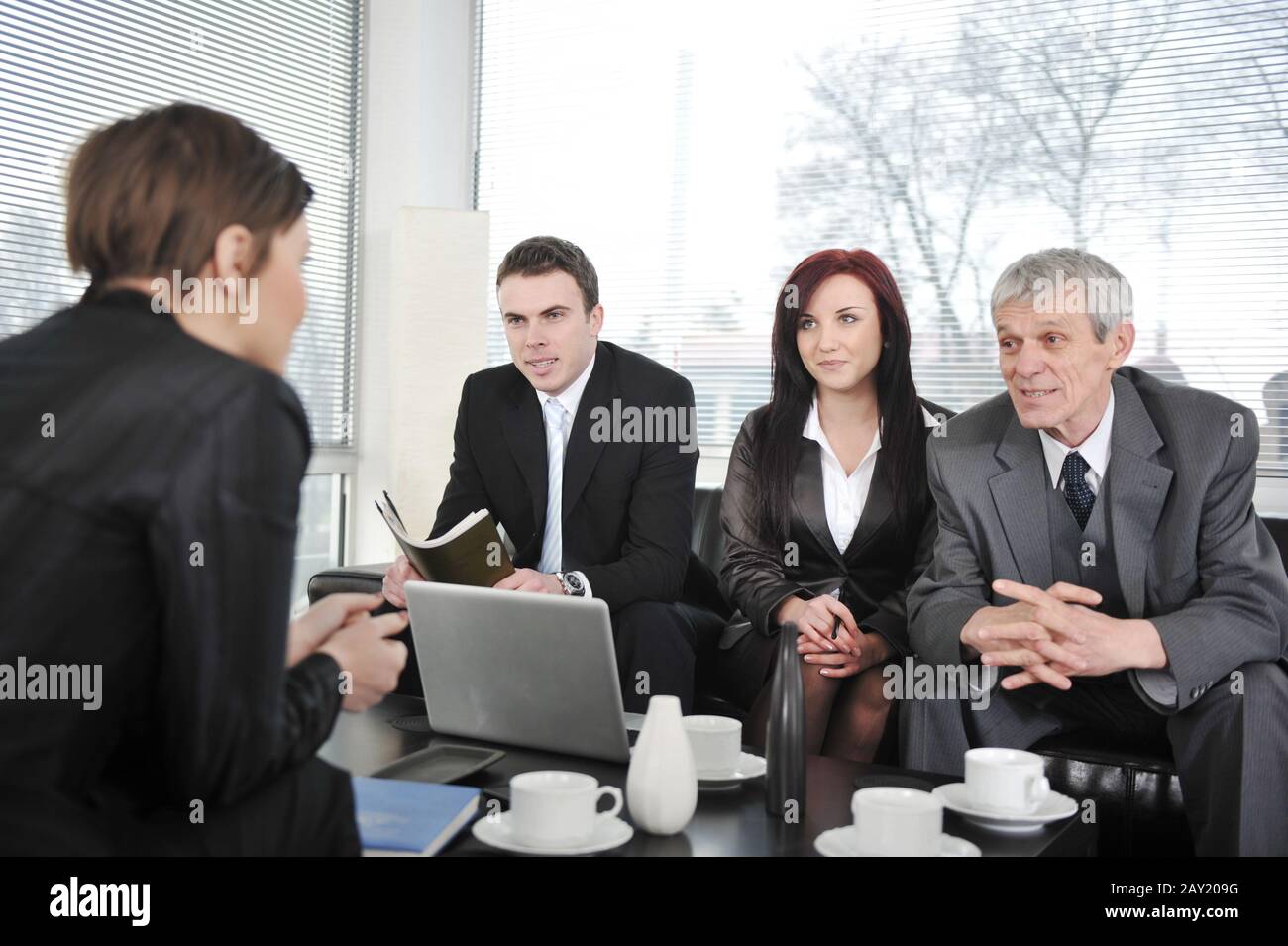 Businesswoman in an interview with three business people Stock Photo ...