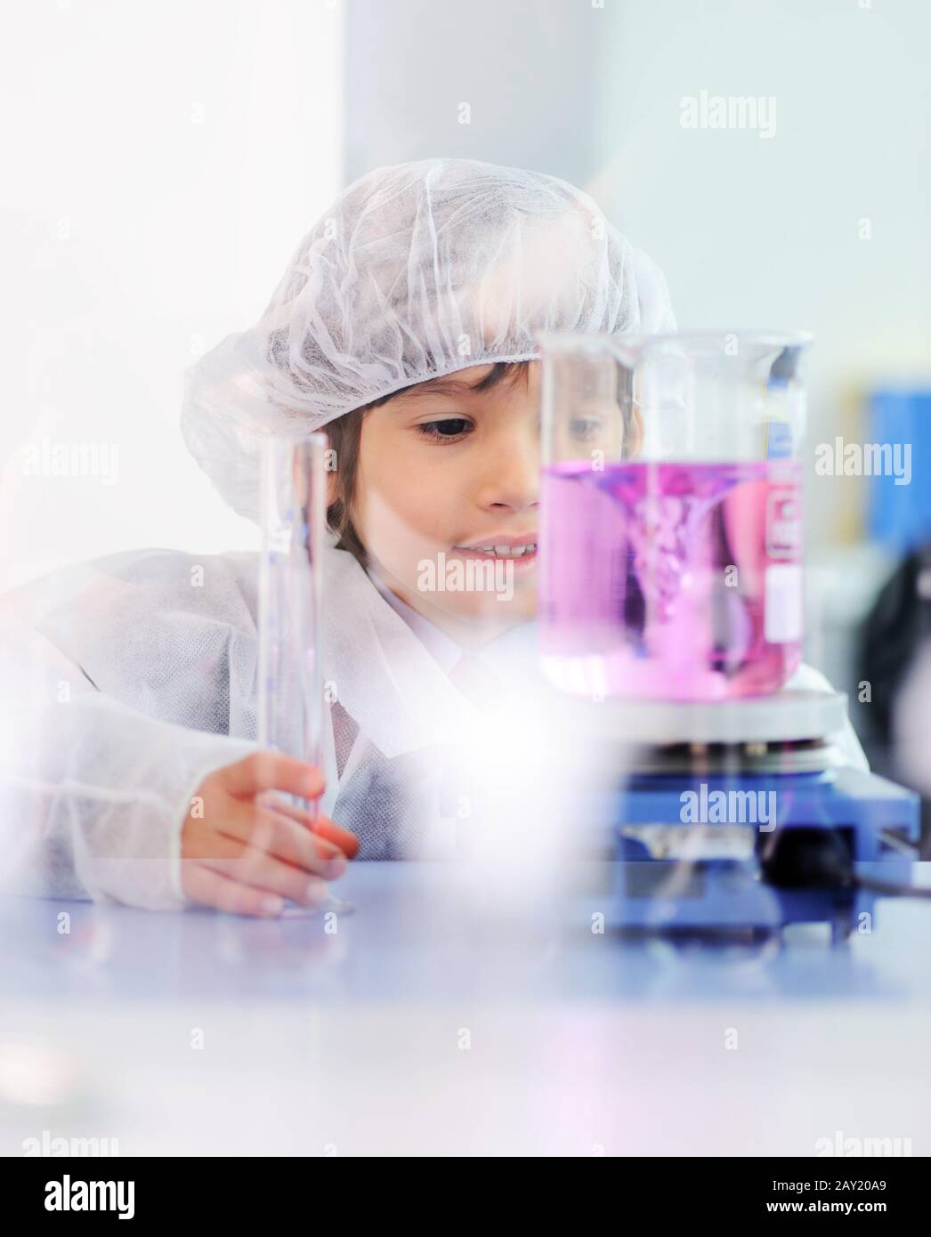 Smart cute little male child experimenting with test tubes in real ...