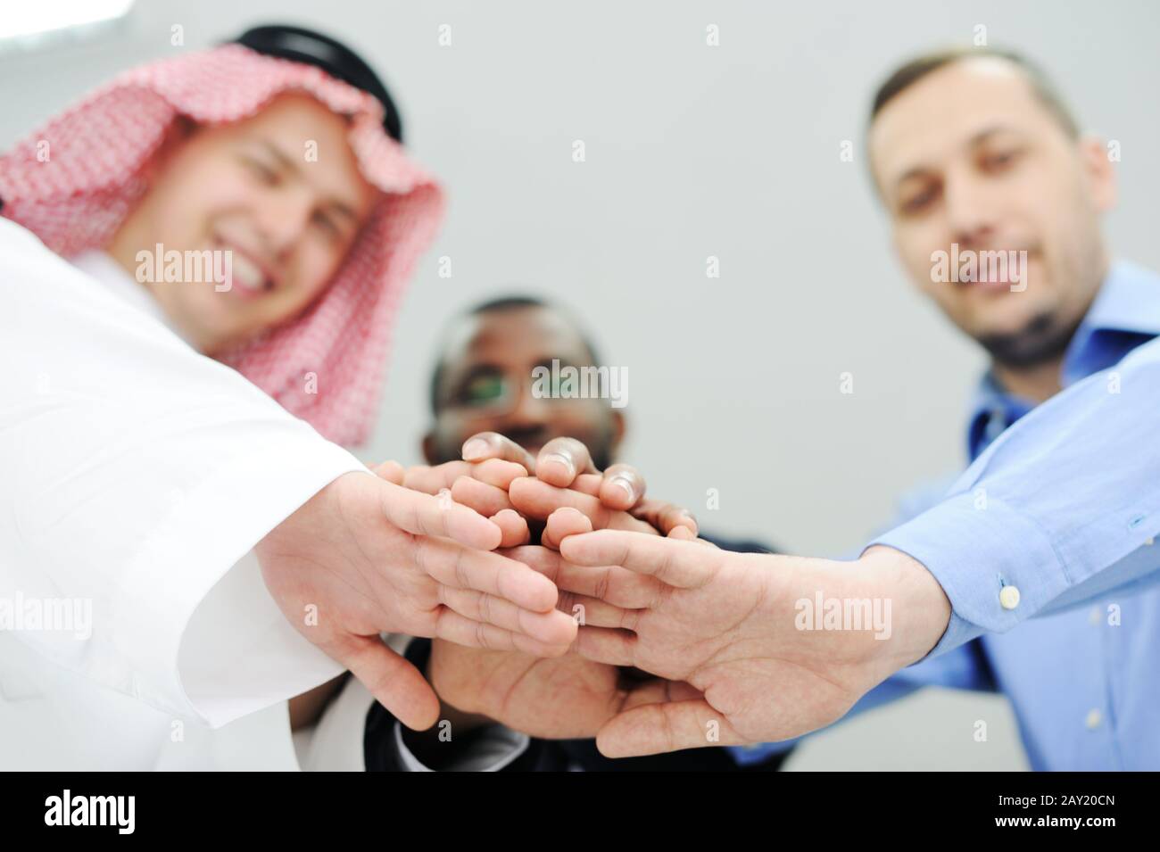 Business team overlapping hands Stock Photo - Alamy