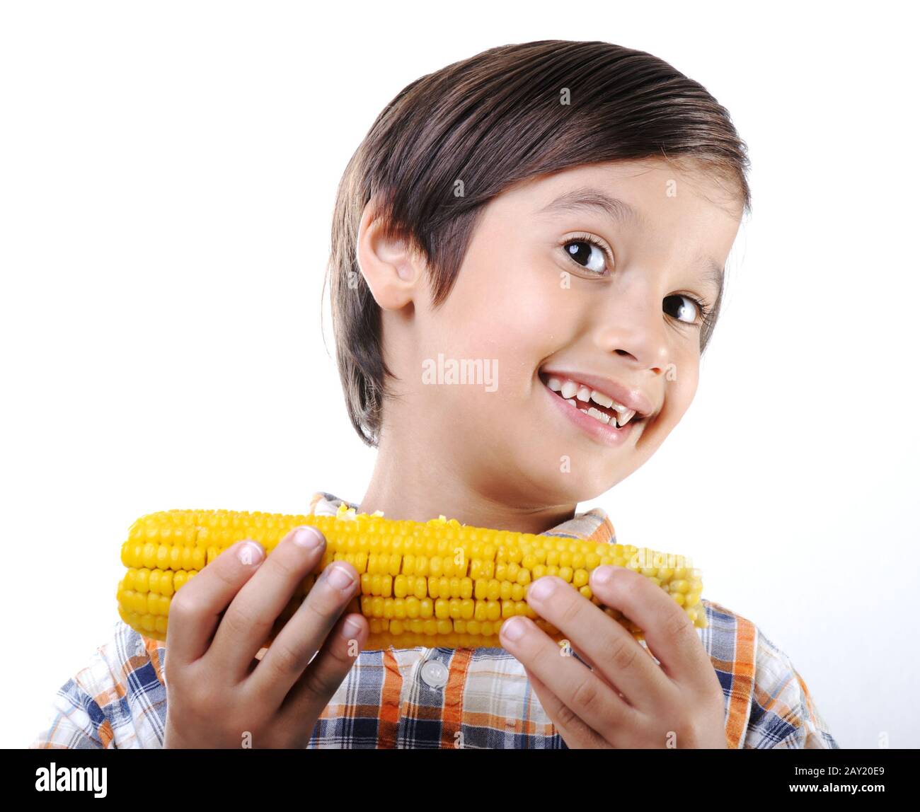 Little boy eating corn Stock Photo - Alamy