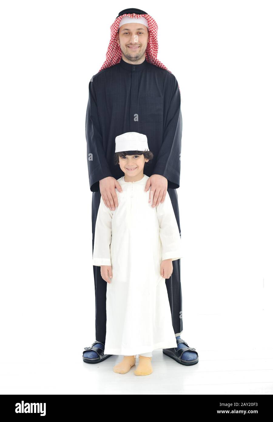 Arabic Muslim father and son standing together Stock Photo - Alamy