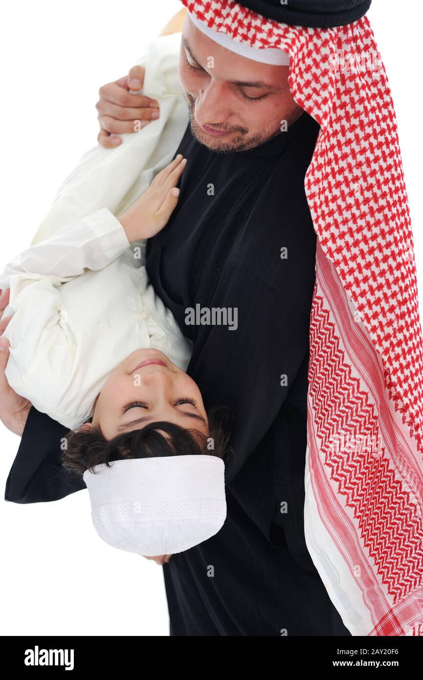 Arabic Muslim father and son standing together Stock Photo - Alamy