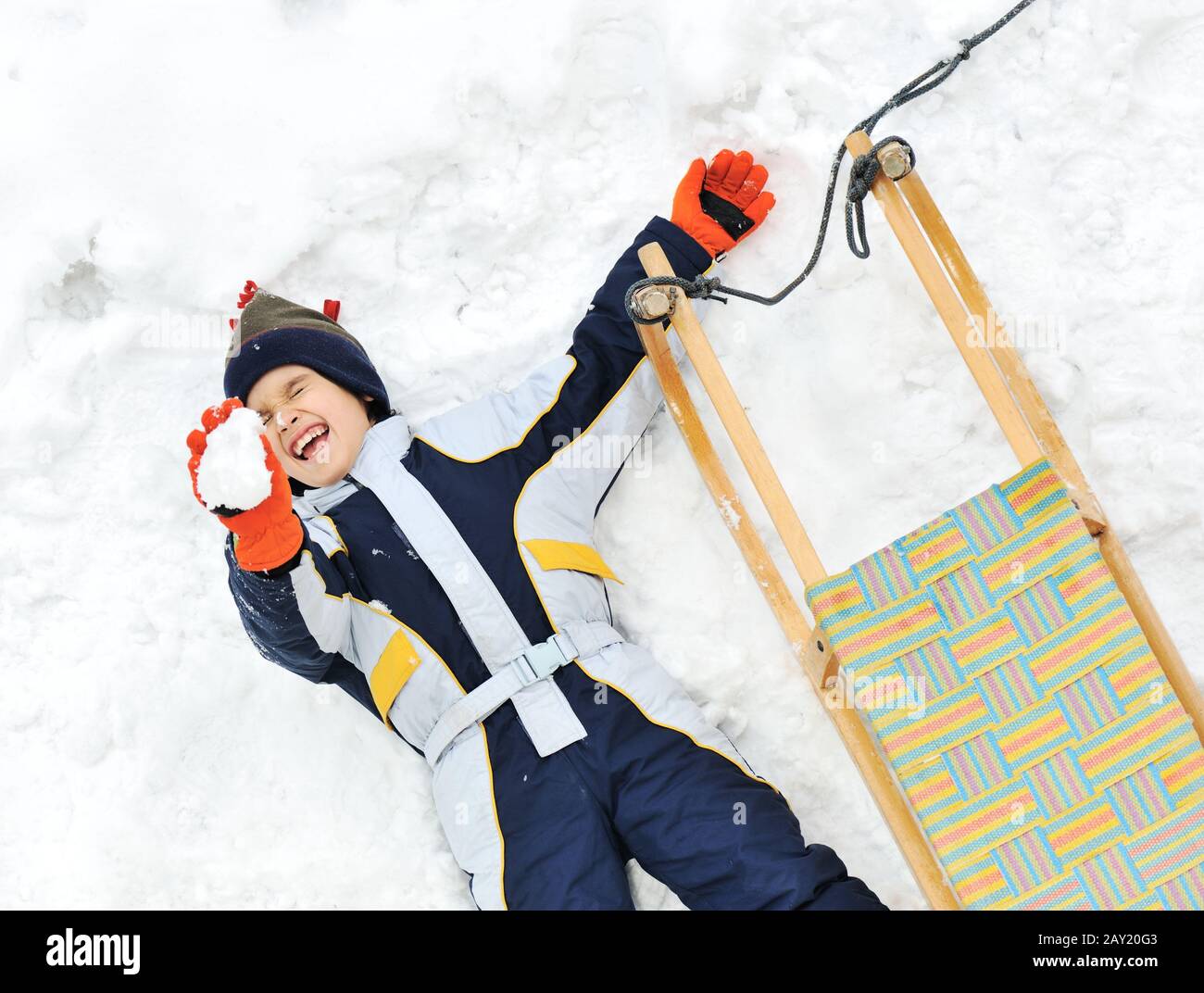 Kids sliding sledge in the snow Stock Photo - Alamy