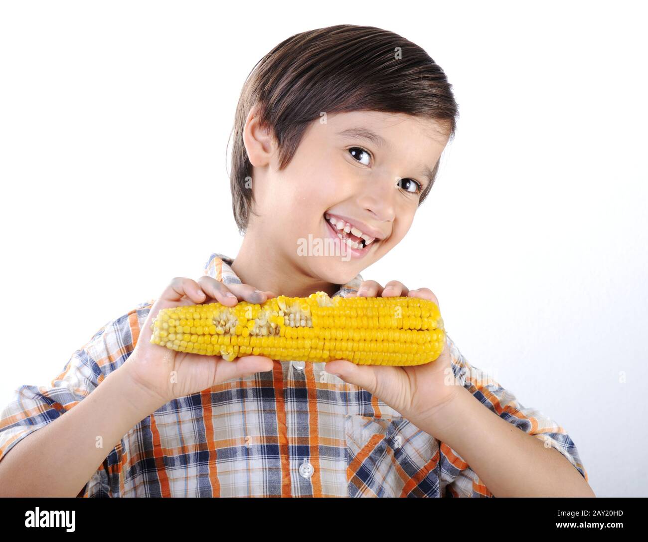 Little boy eating corn Stock Photo - Alamy