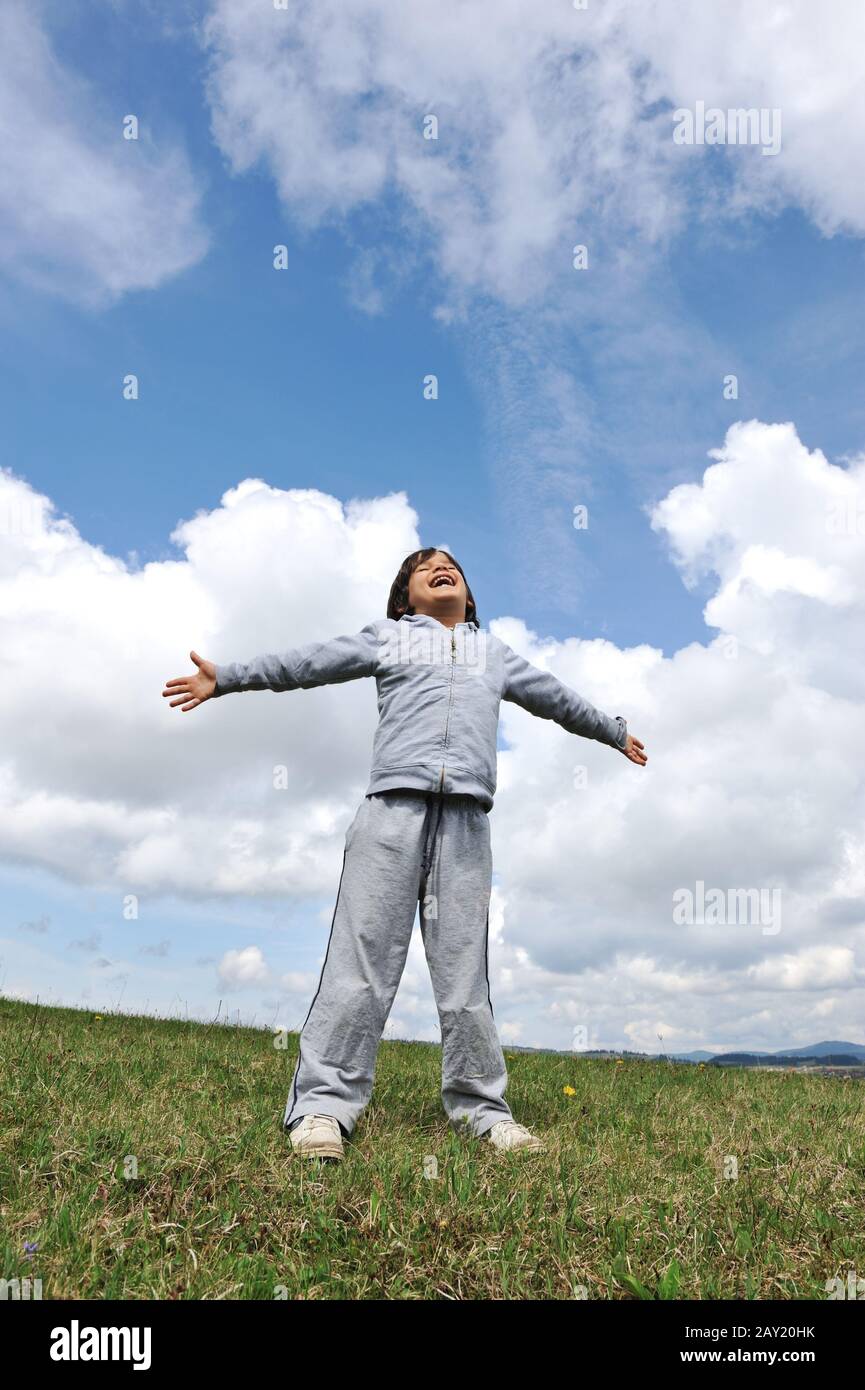 Little boy feeling a freedom on meadow in nature Stock Photo - Alamy