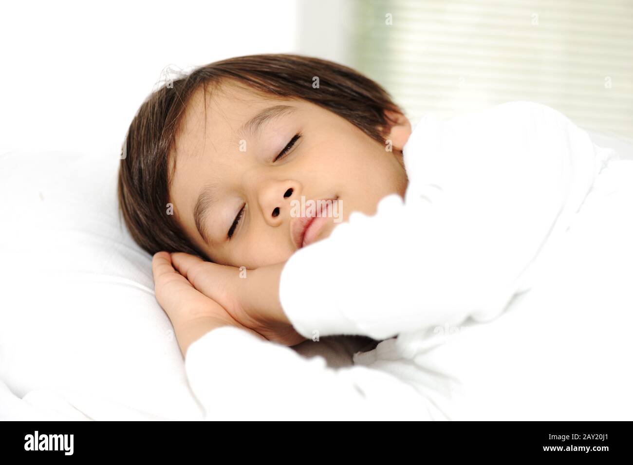 Kid on sleeping bed Stock Photo - Alamy