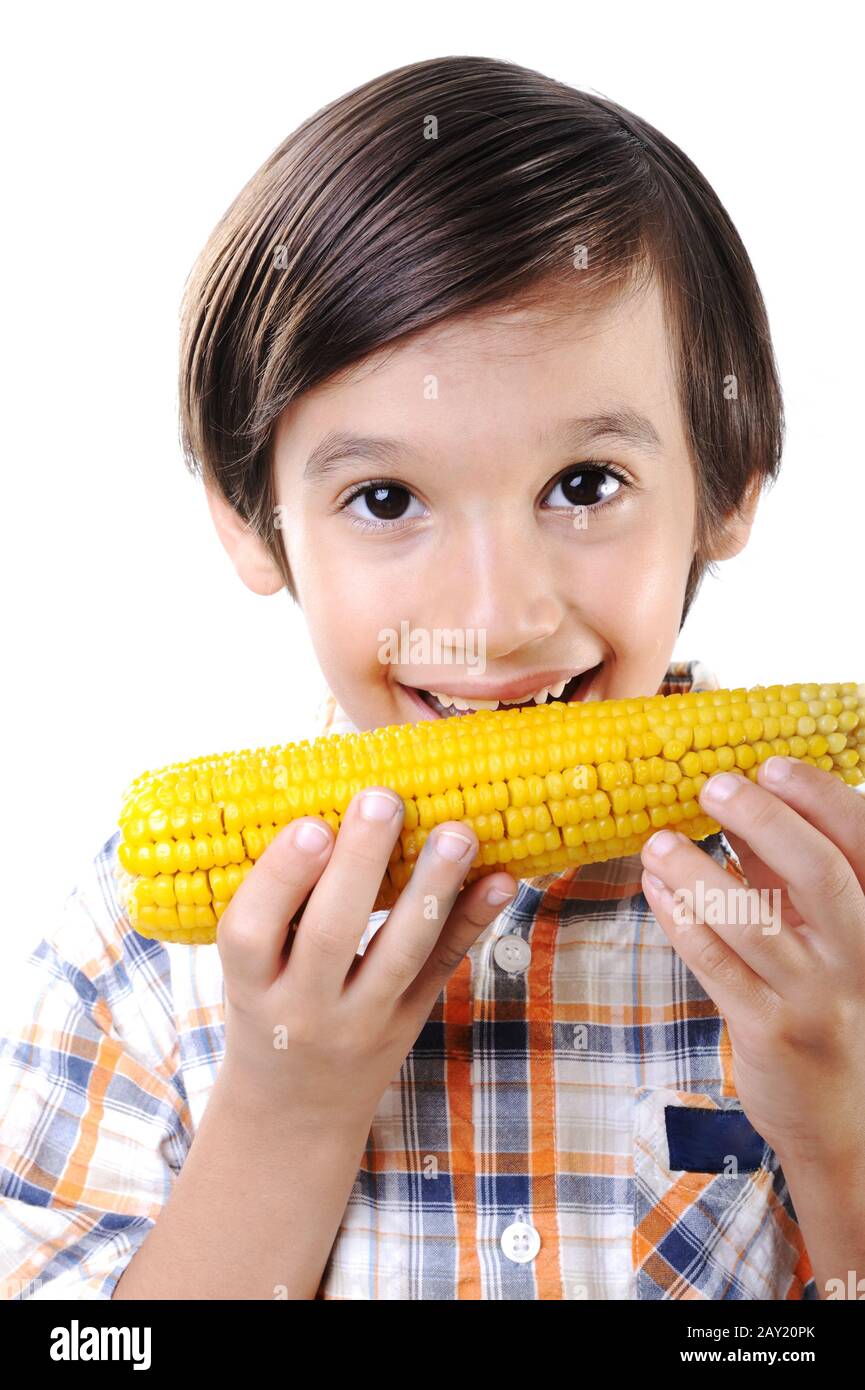 Little boy eating corn Stock Photo - Alamy