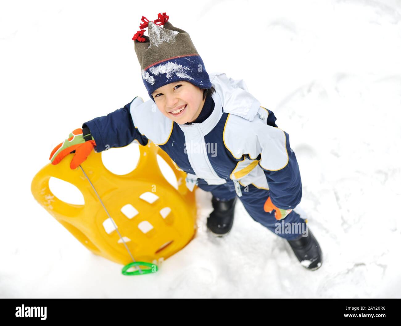 Kids sliding sledge in the snow Stock Photo - Alamy