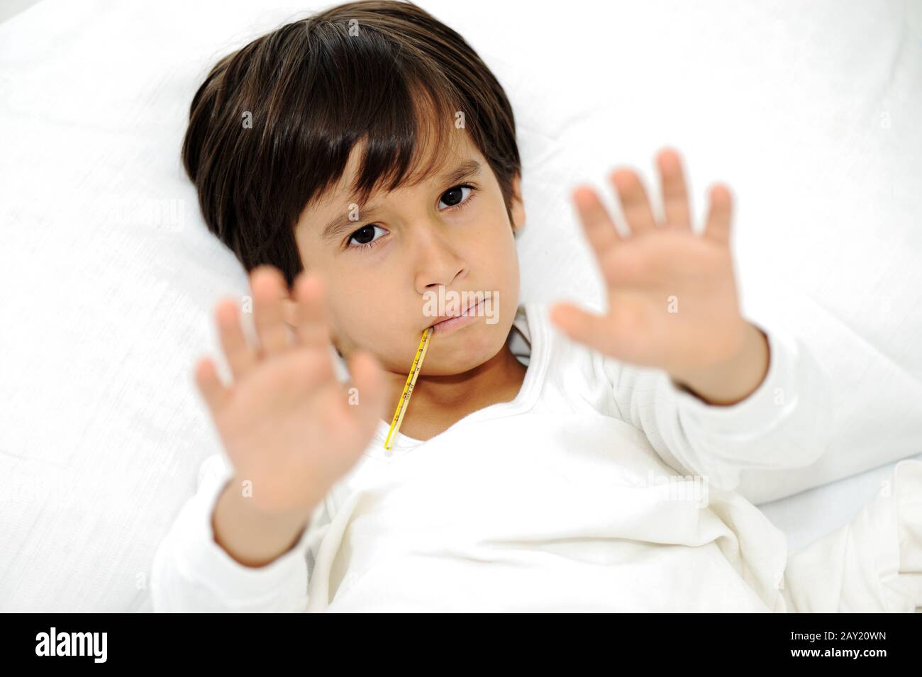 Sick little boy with thermometer Stock Photo - Alamy