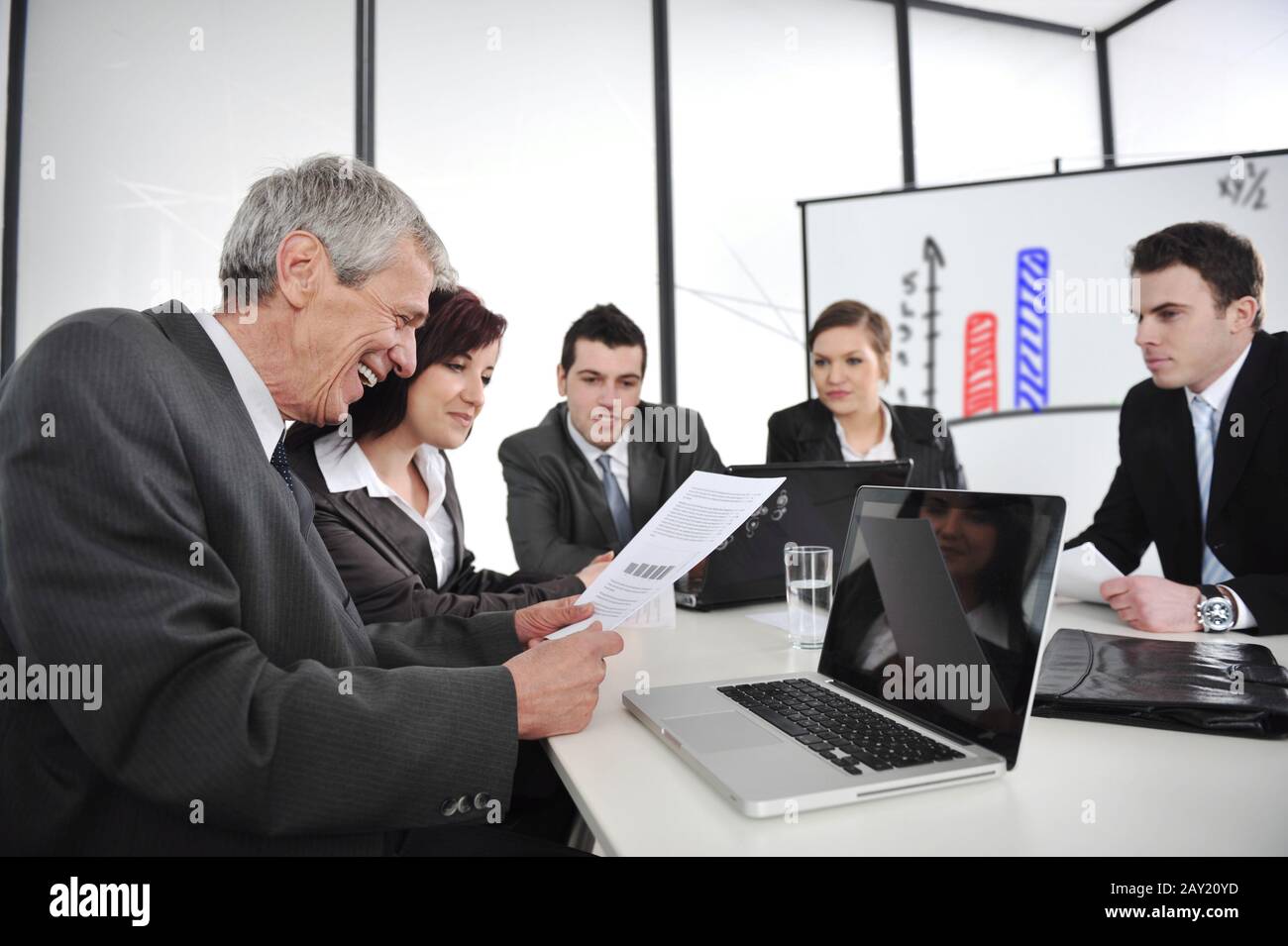 Boss reading report at business meeting Stock Photo - Alamy