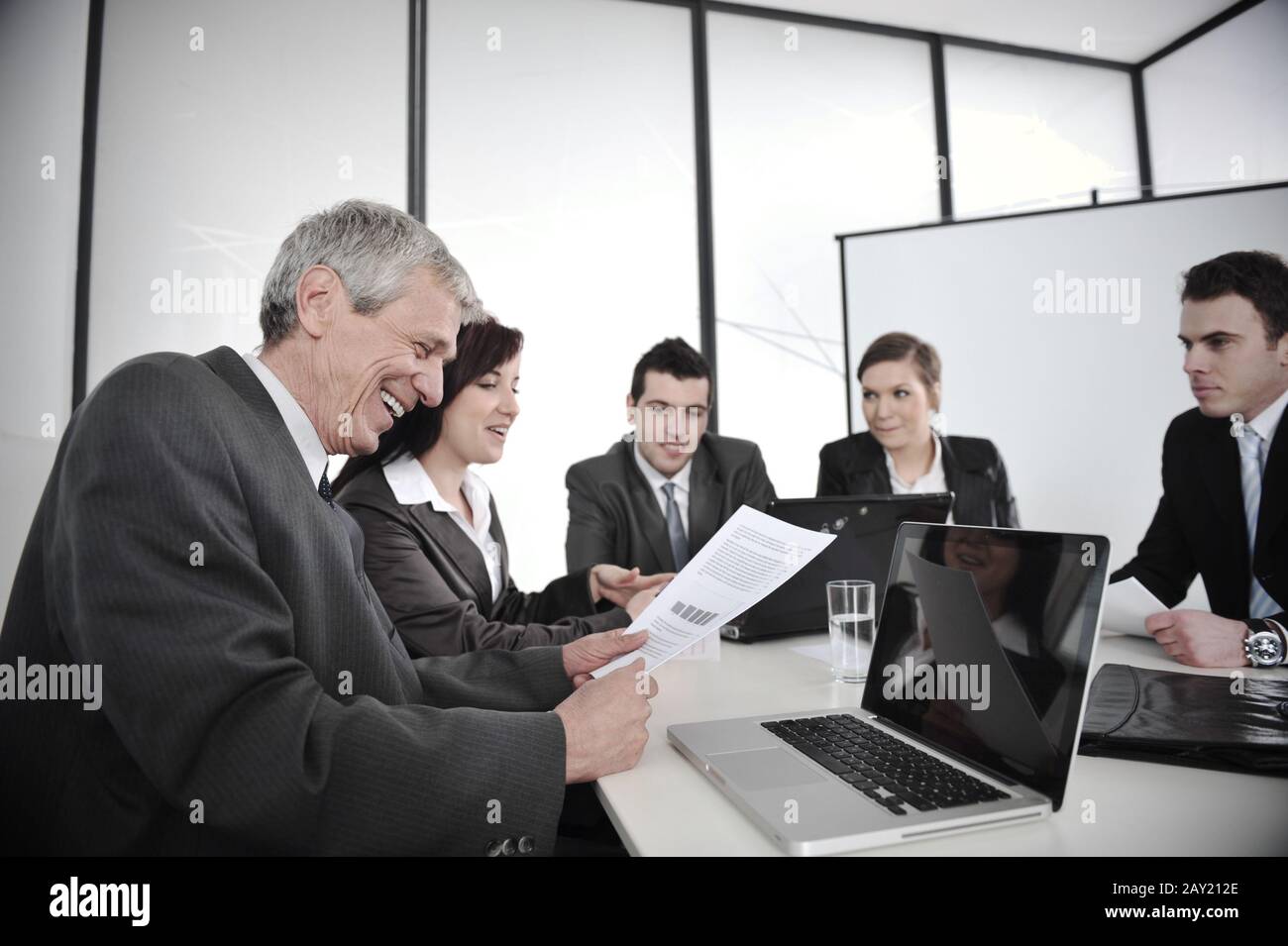 Boss reading report at business meeting Stock Photo - Alamy