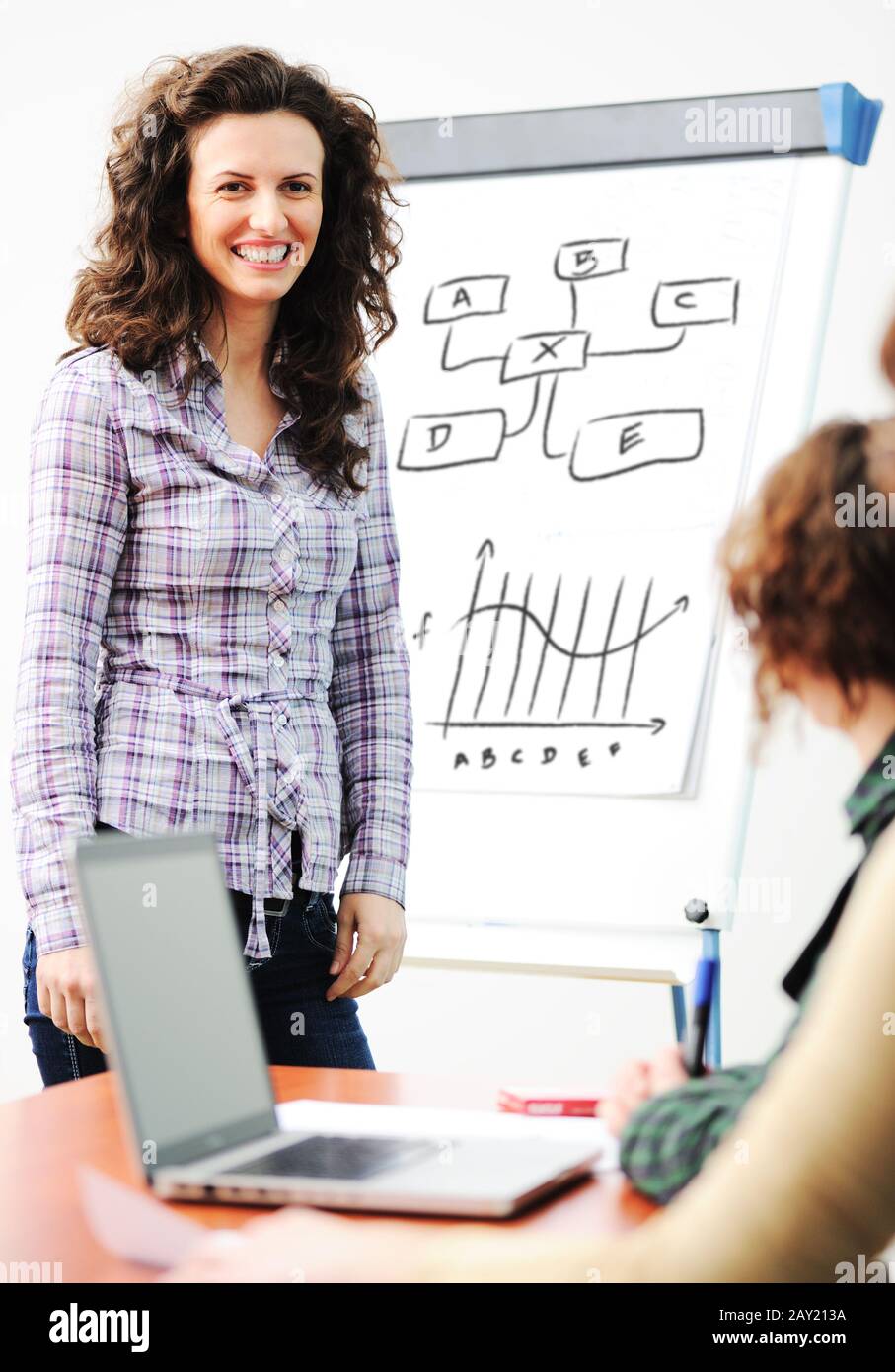 Female executive making presentation to her colleagues in modern ...