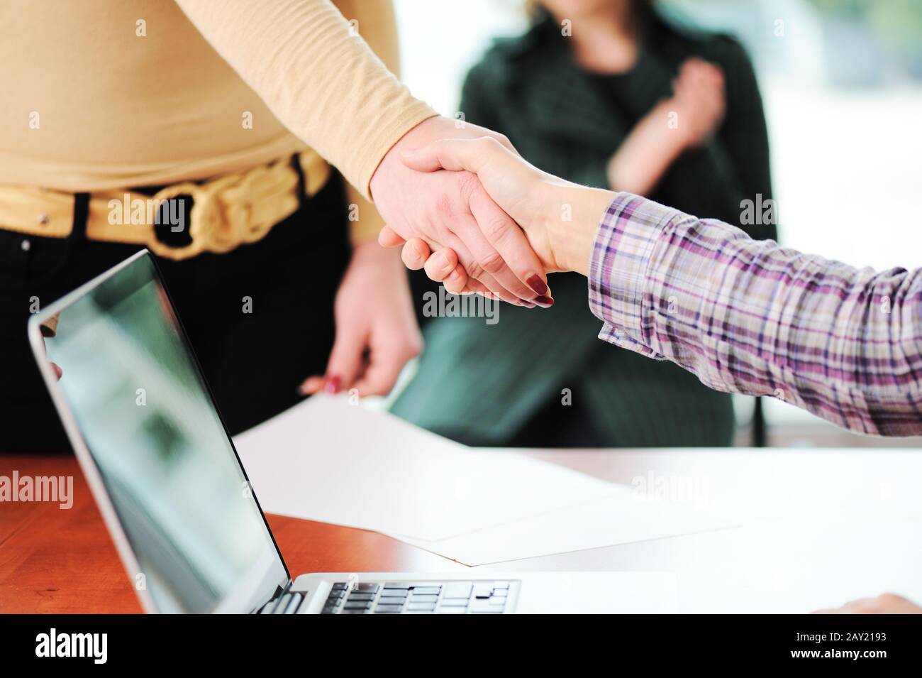 Closing a successful deal with a handshake. Signed contract and ...