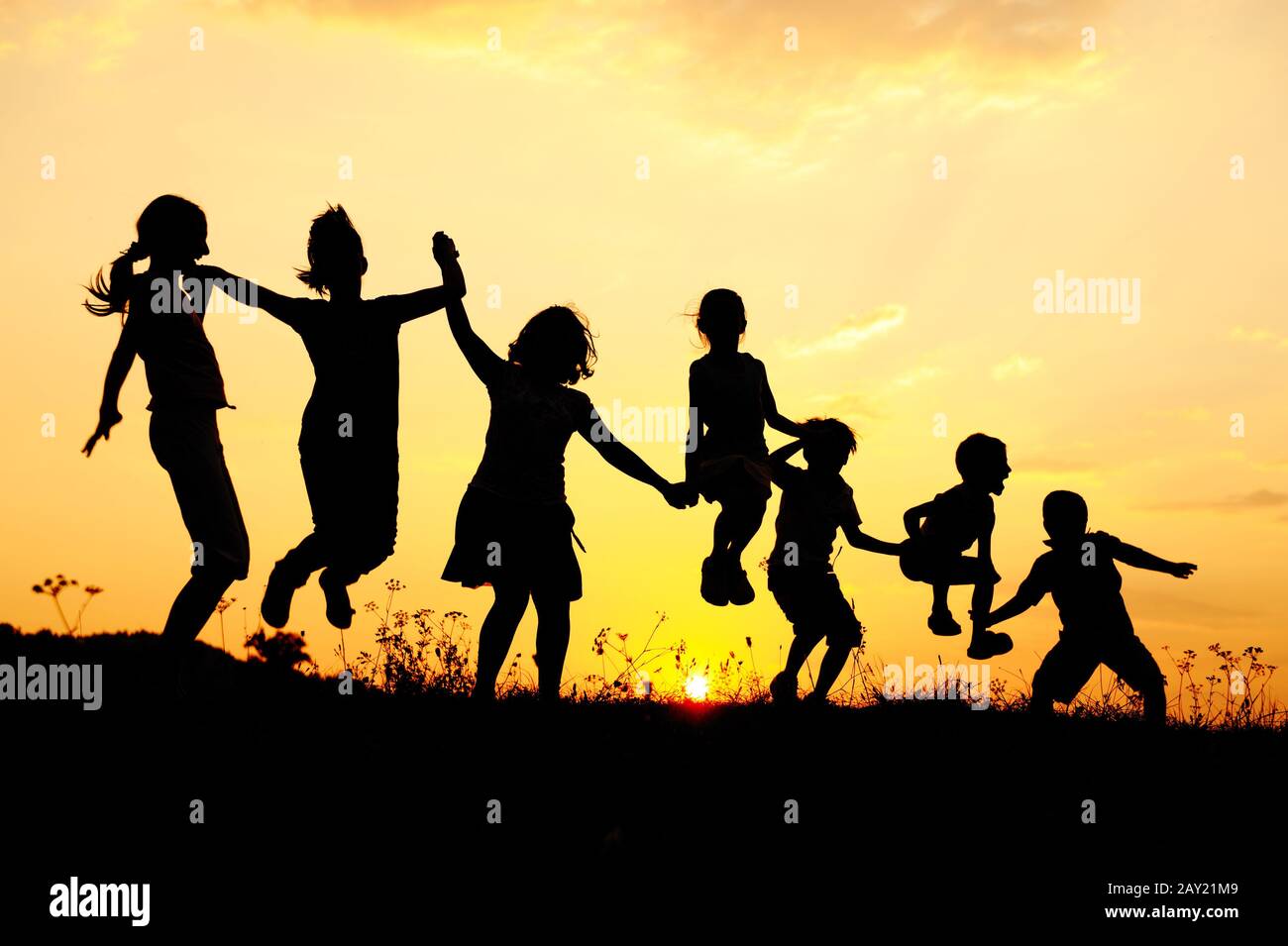 Beautiful scene of children jumping in nature Stock Photo - Alamy