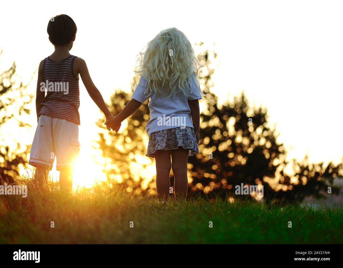 Happy children in nature at sunset Stock Photo - Alamy