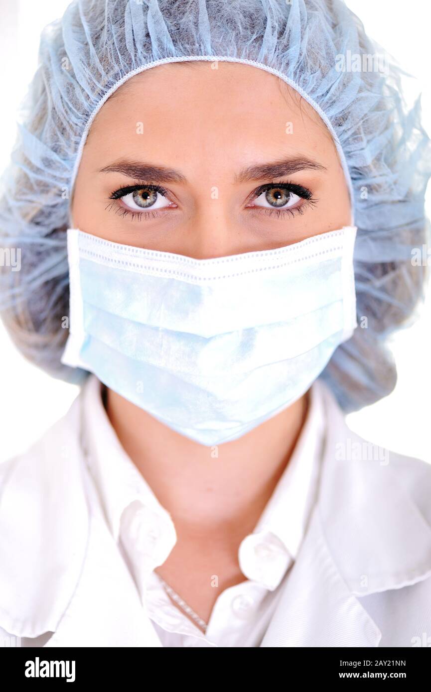 Female doctor wearing surgical cap and mask Stock Photo - Alamy