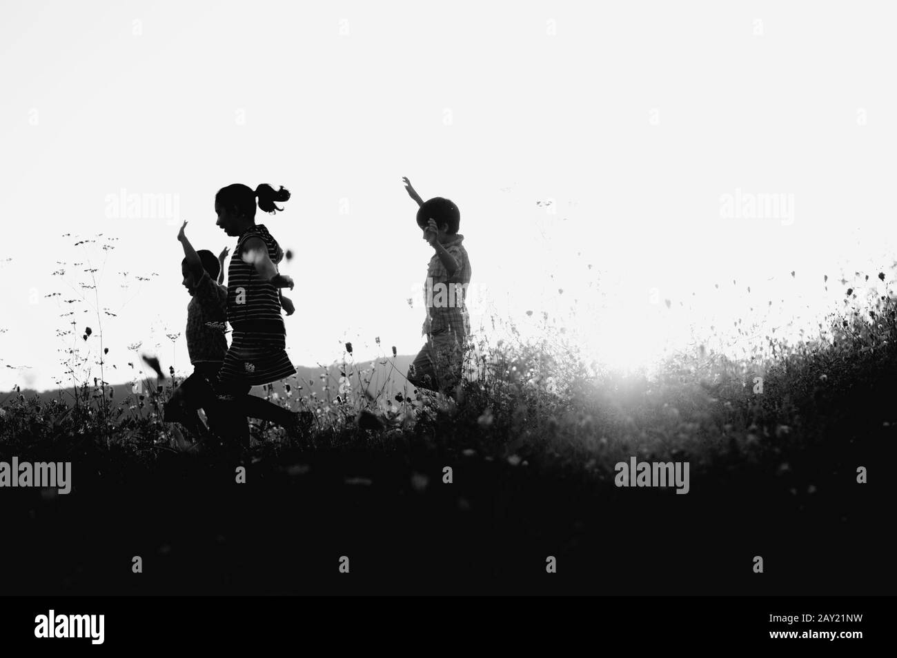 Three children in colorful Black and White Stock Photos & Images - Alamy