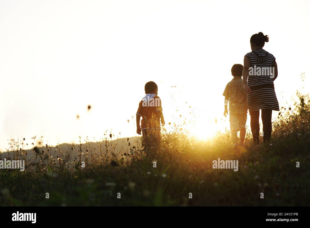 Happy children in nature at sunset Stock Photo - Alamy