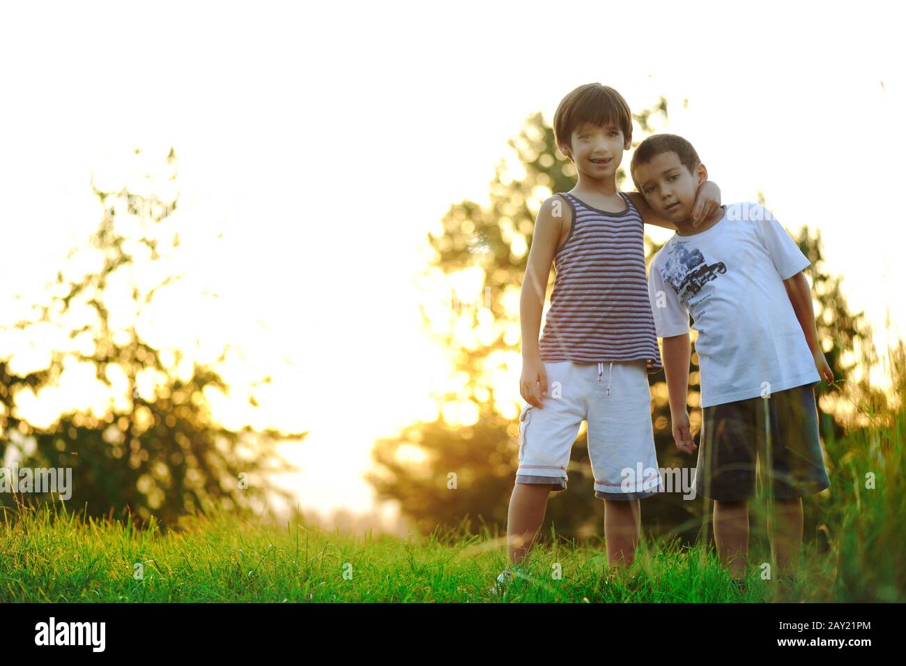 Happy children in nature at sunset Stock Photo - Alamy