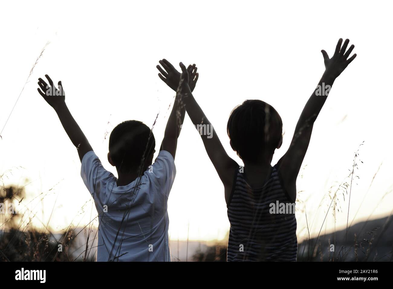 Happy children in nature at sunset Stock Photo - Alamy