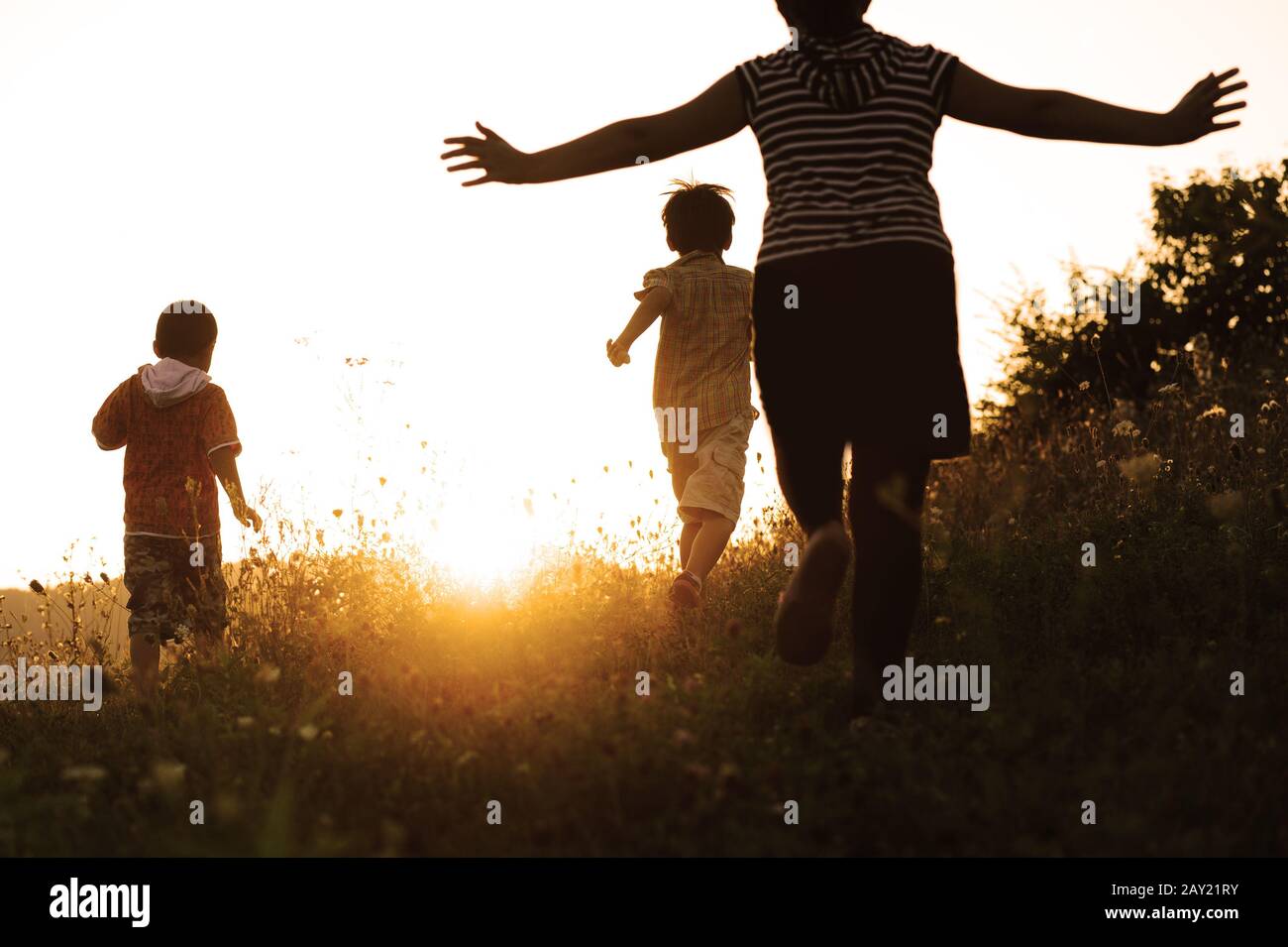Happy children in nature at sunset Stock Photo - Alamy