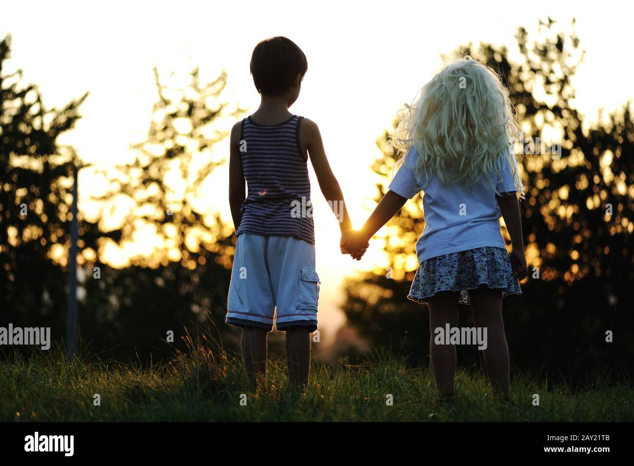 Happy children in nature at sunset Stock Photo - Alamy