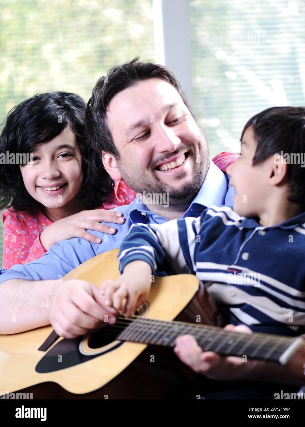Happy family playing guitar together Stock Photo - Alamy