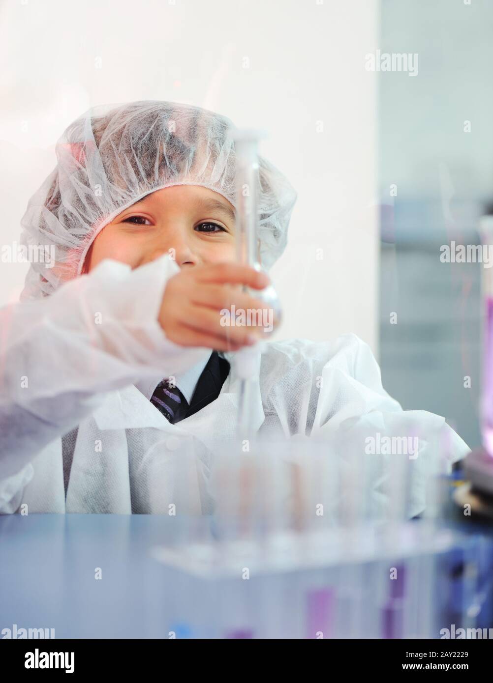 Smart cute little male child experimenting with test tubes in real ...