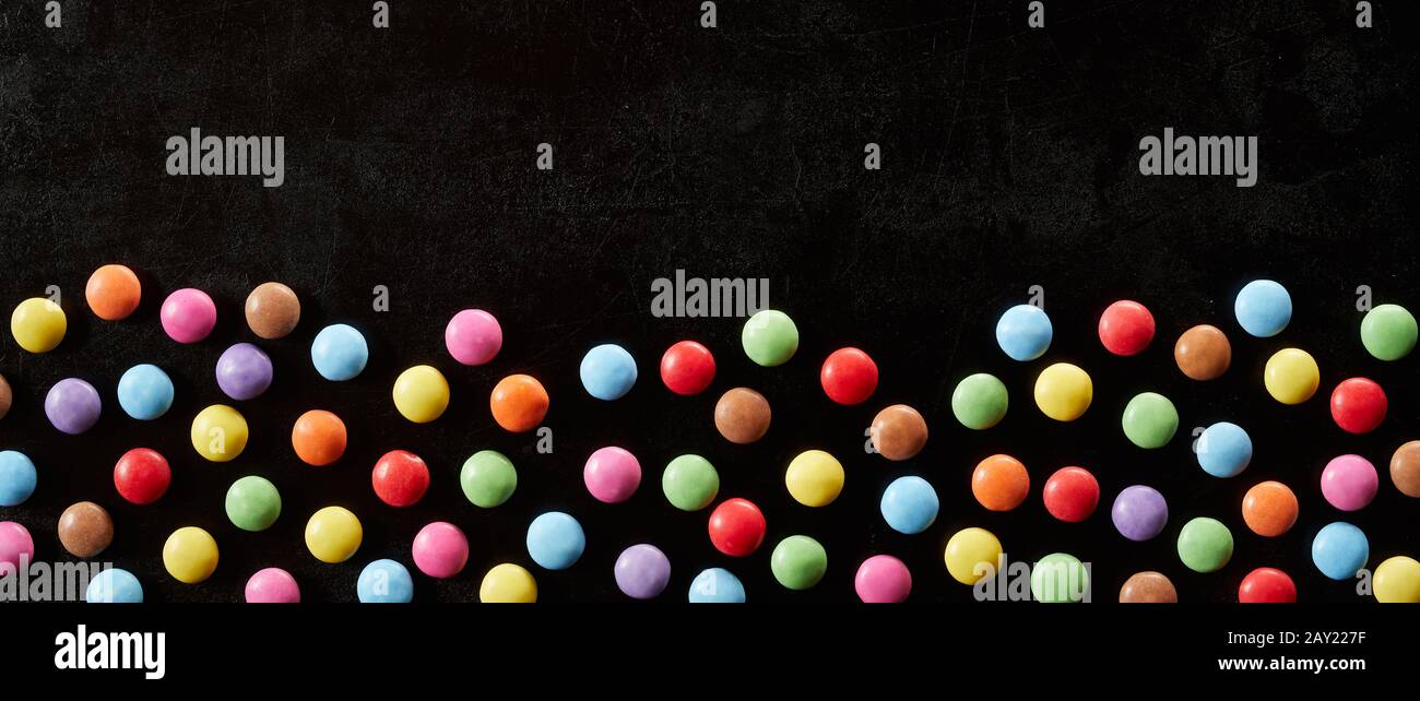 Panorama banner with vibrant rainbow colored sugar-coated candy border ...