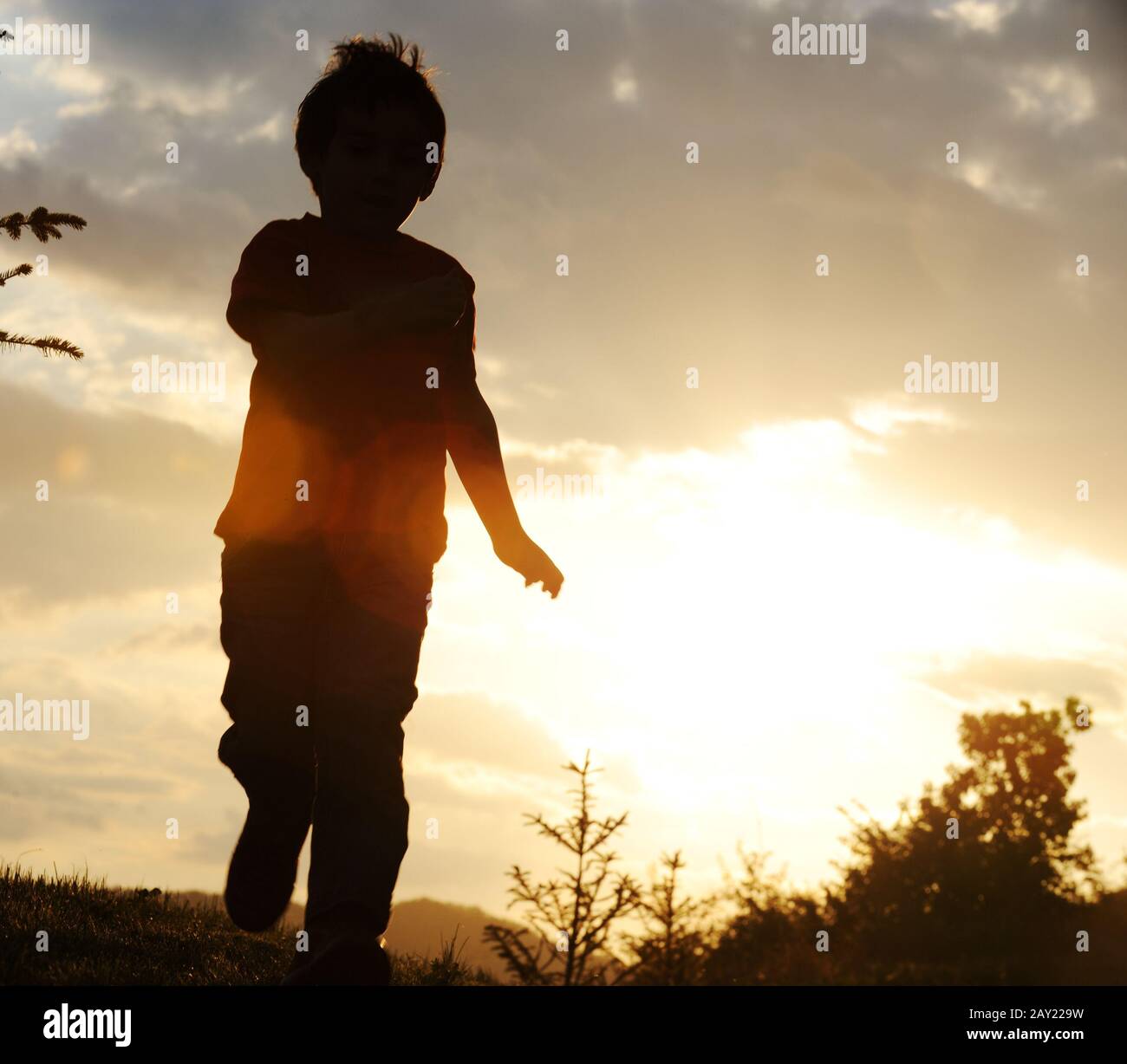 Kid running on field Stock Photo - Alamy