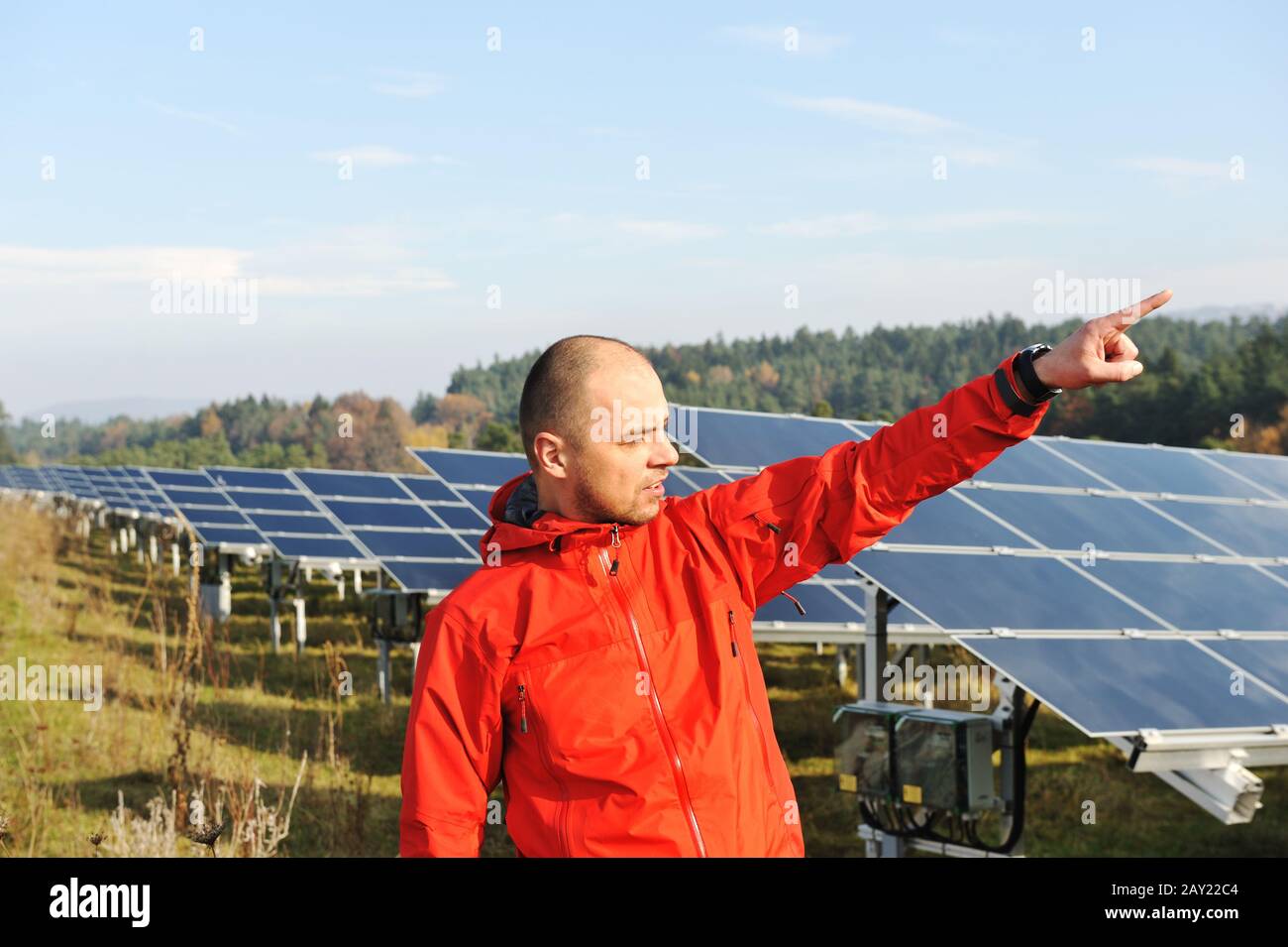 Male worker at solar panel field Stock Photo - Alamy