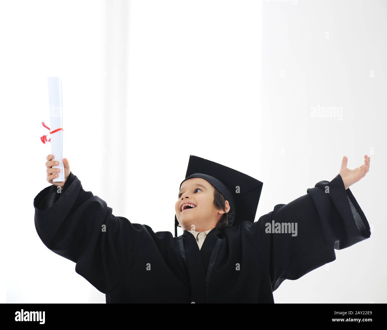 Happy successful kid with diploma and graduating clothes Stock Photo ...