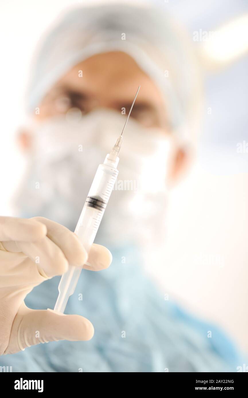 Doctor surgeon holding an injection at surgery room Stock Photo - Alamy