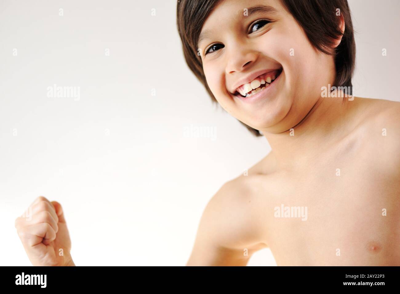 Child showing the muscles of his arms Stock Photo - Alamy