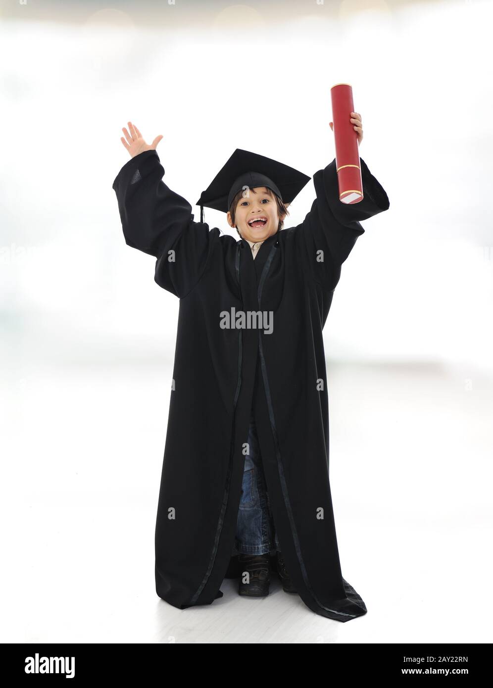 Happy successful kid with diploma and graduating clothes Stock Photo ...