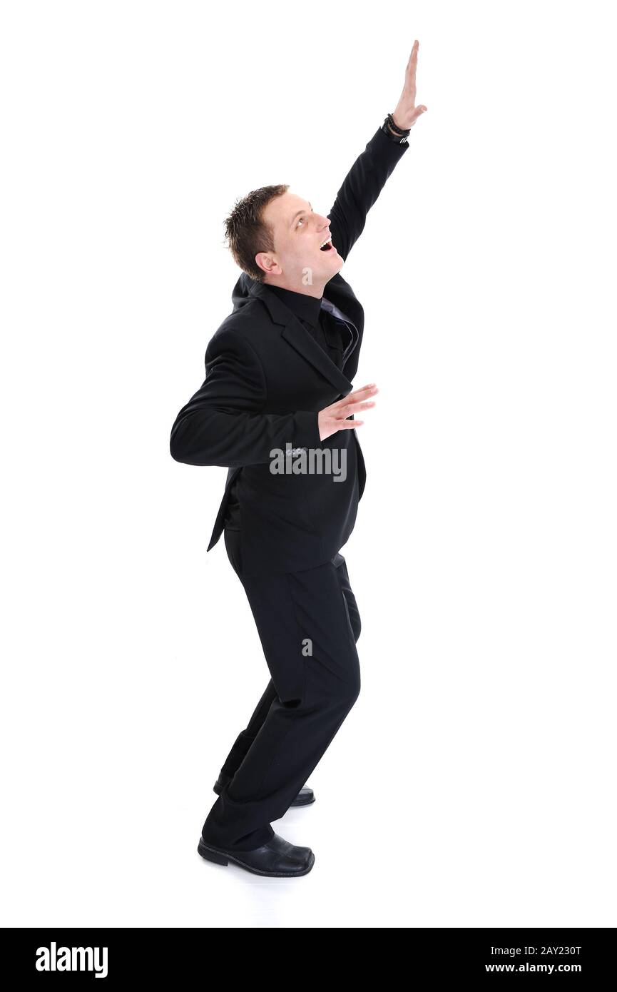 Portrait of a young successful businessman celebrating with his arms ...