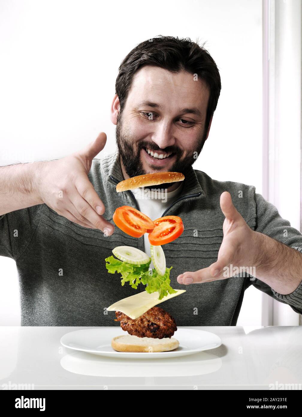 Adult man making a burger Stock Photo - Alamy