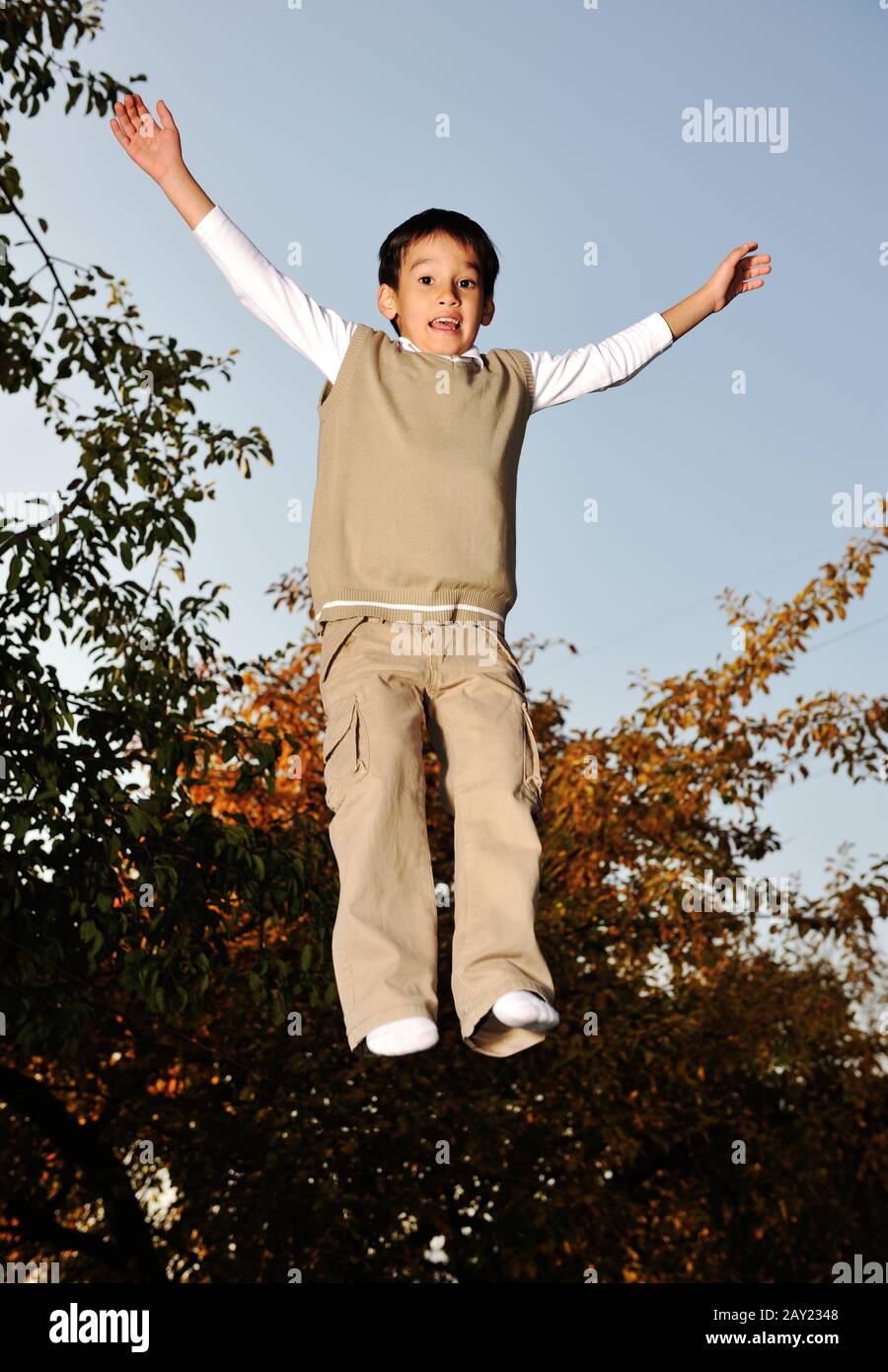 Kid jumping very high Stock Photo - Alamy