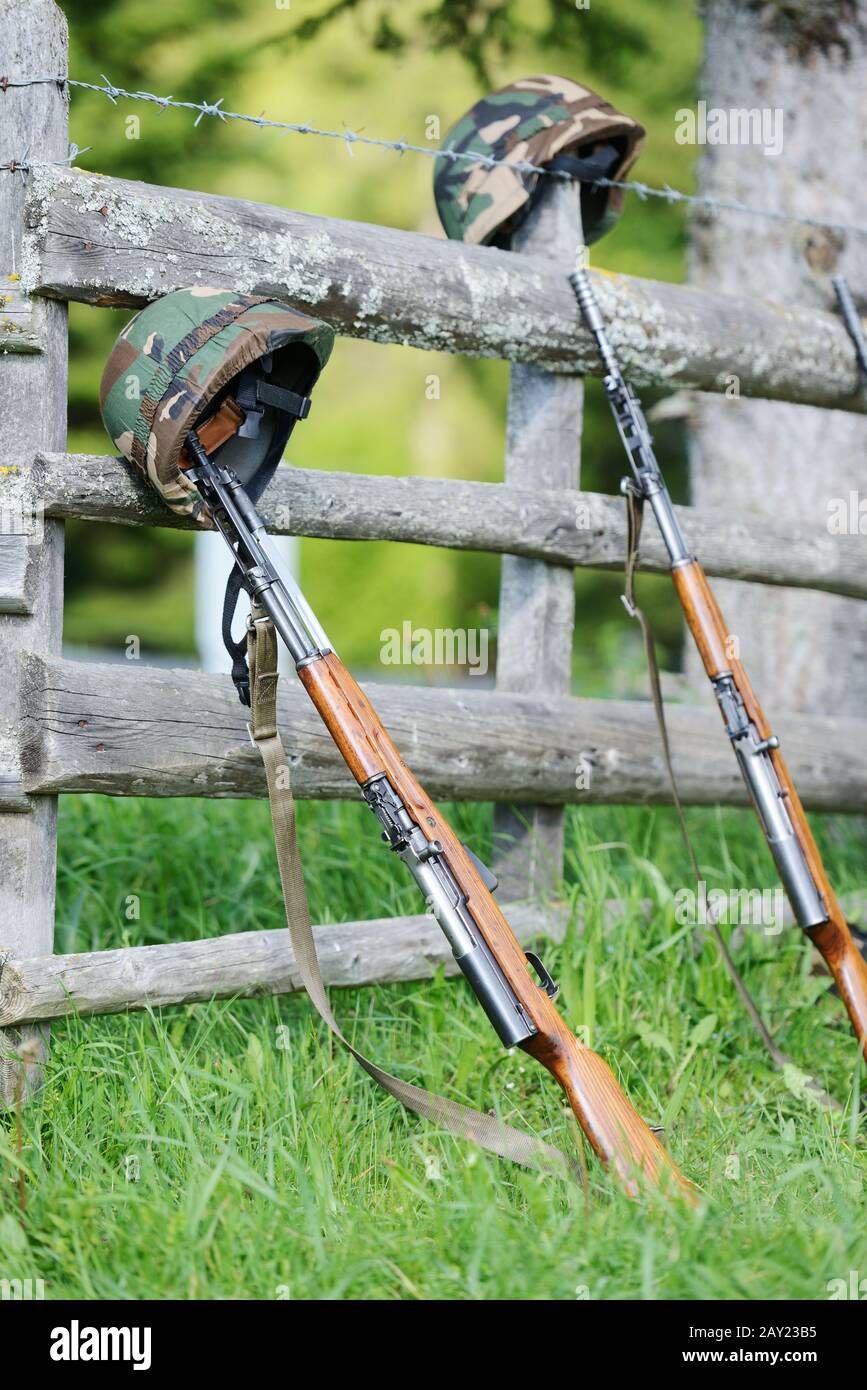Military rifle and helmet Stock Photo - Alamy