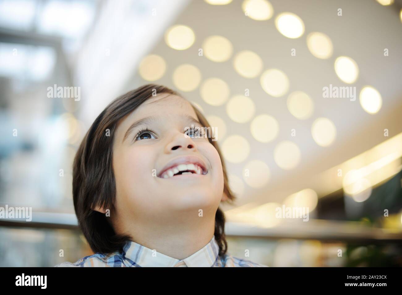 Happiness of a kid in shopping mall Stock Photo - Alamy