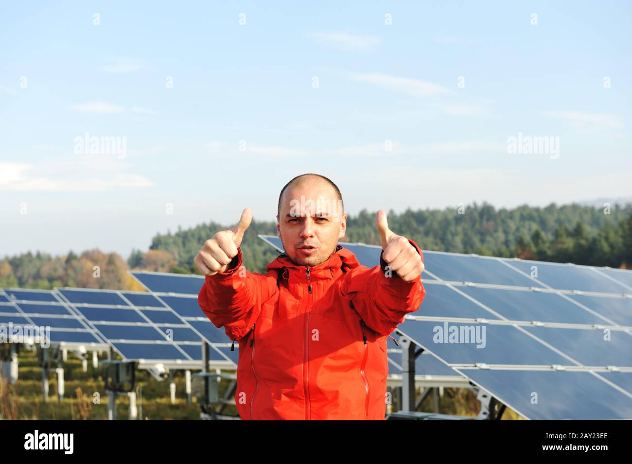 Male worker at solar panel field Stock Photo - Alamy