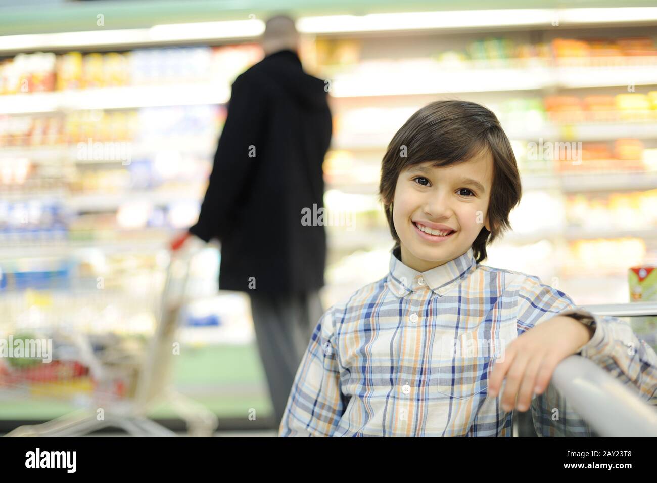 Boy in supermarket Stock Photo - Alamy