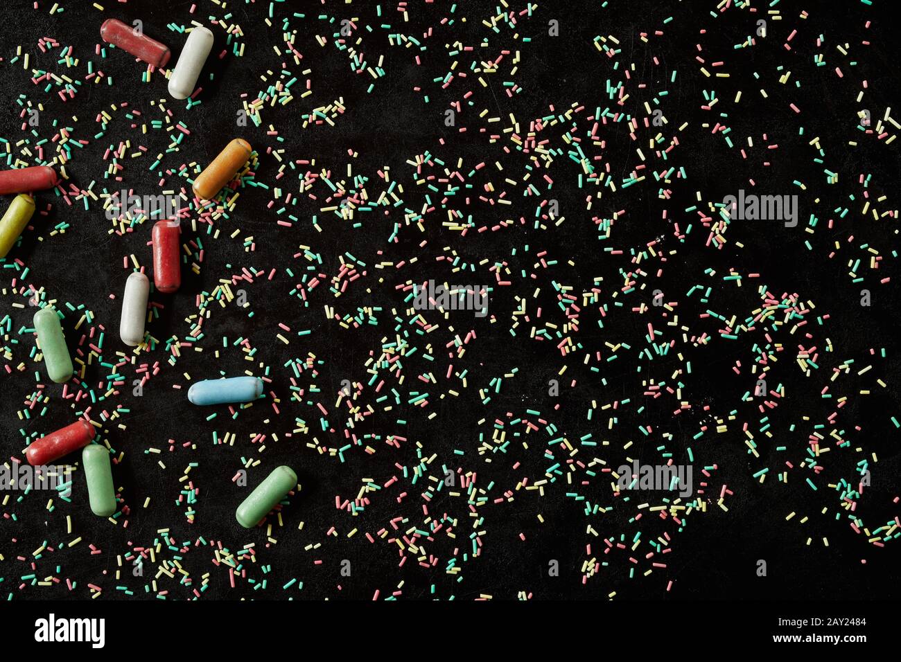 Background texture of colorful baking sprinkles with a border of sugar ...